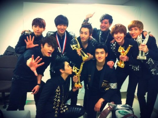 Super Junior's Donghae shows off their four 'Golden Disk' trophies ...