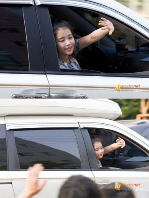 An exhausted IU greets her fans with a wave | allkpop