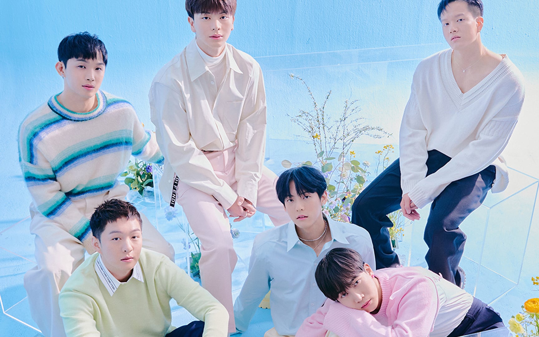 BTOB members sit together in pastel setting in the group teaser photo ...