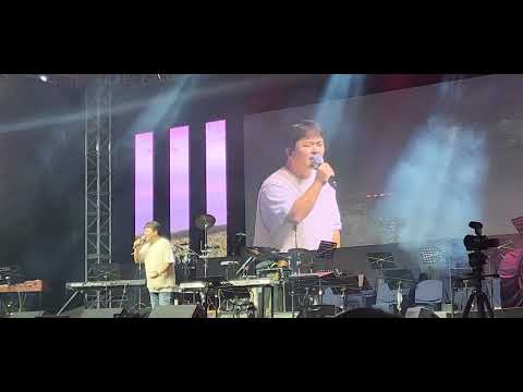 A man barges on stage during singer Huh Gak's outdoor performance and ...