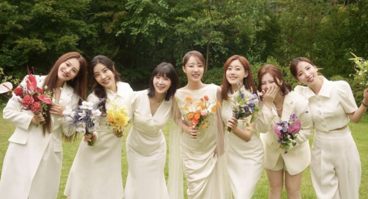 Rainbow members hold rainbow bouquets as they pose for member Woori's ...