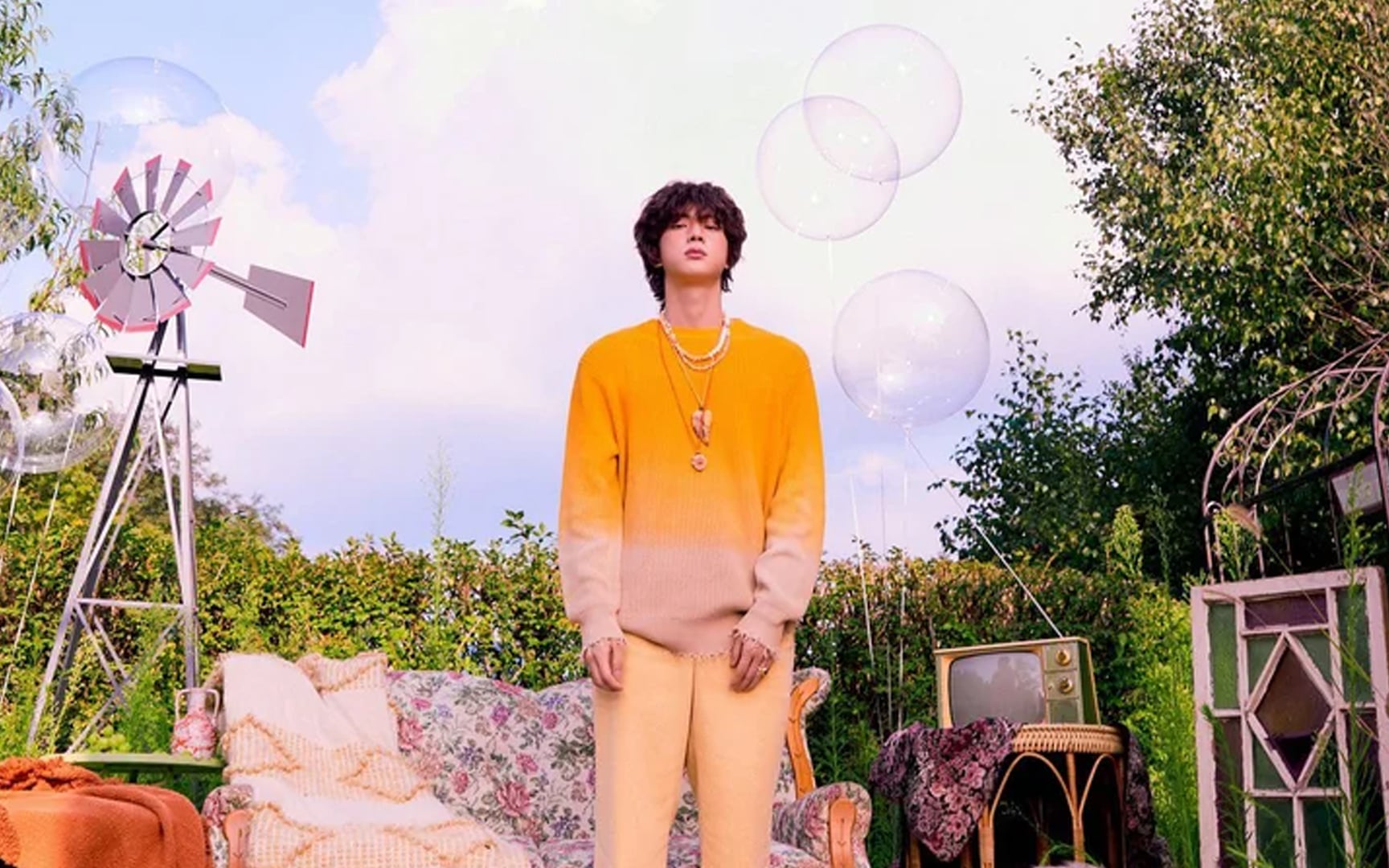 BTS's Jin spends a day in the warm sun after landing on earth in the ...